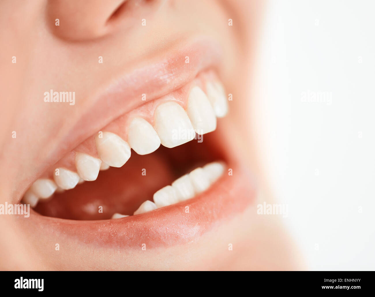 Toothy smile of a young woman Stock Photo - Alamy