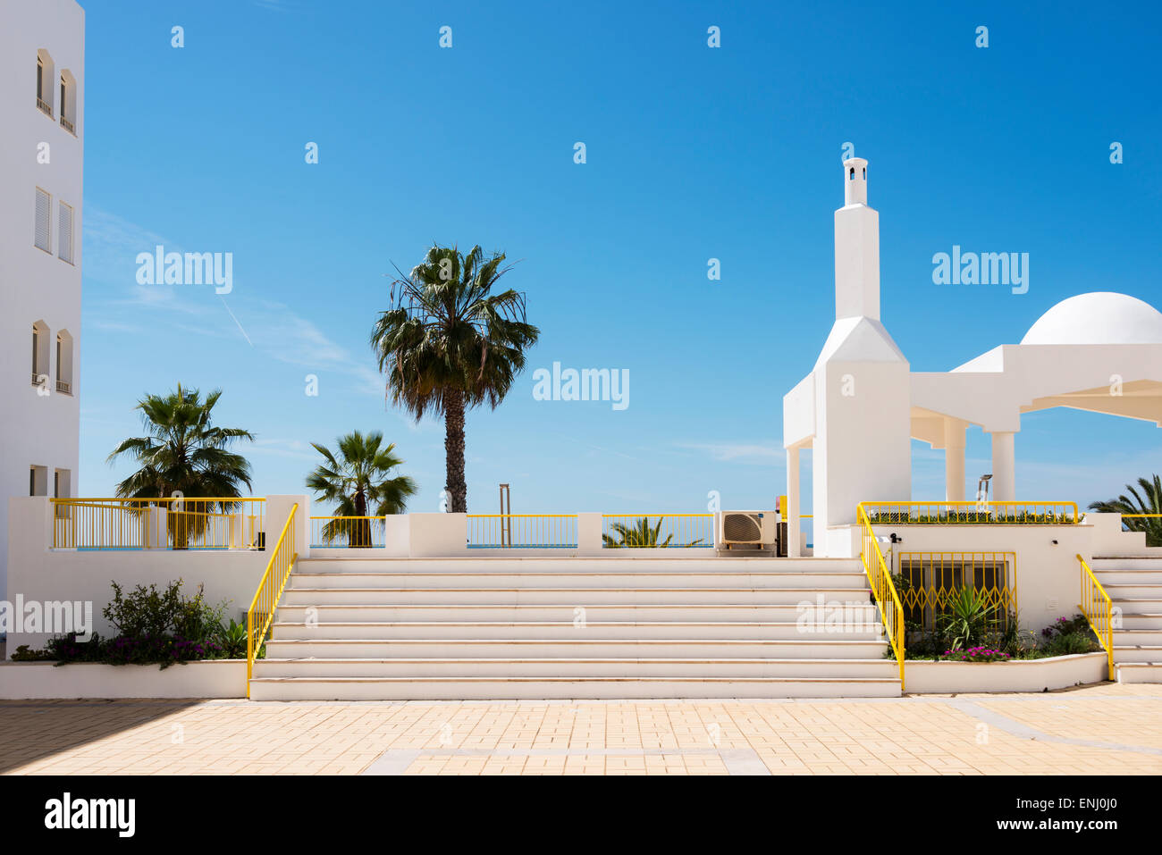 typical portugese style white building on the boulevard of quarteira in ...