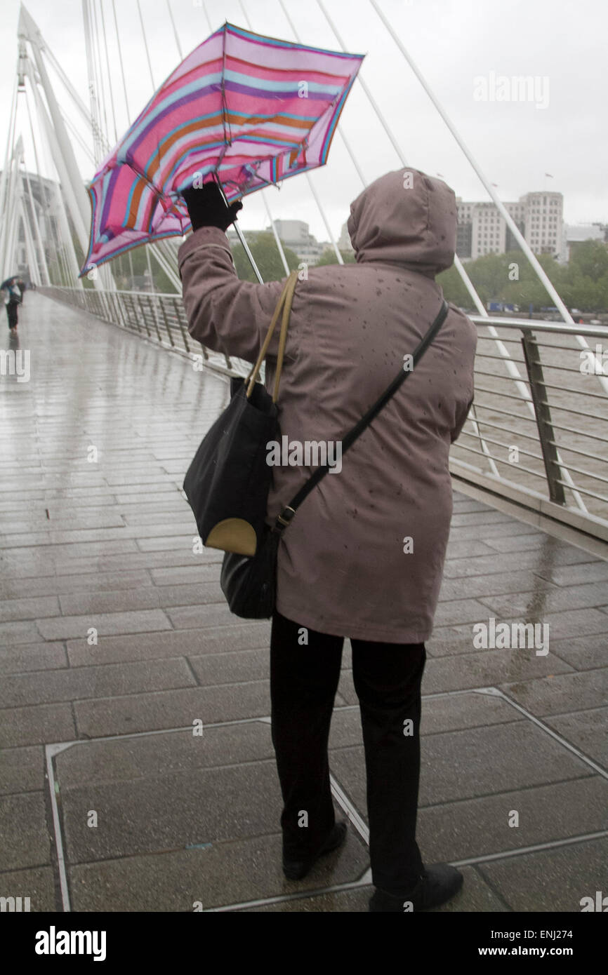 London, UK. 6th May, 2015. UK Weather: People are caught in gale force ...
