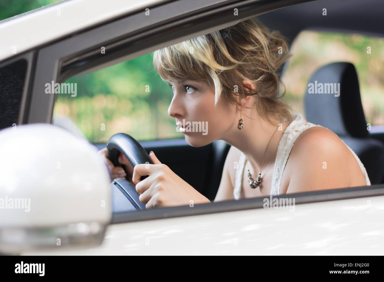 Young Woman Learning to Drive Car and Leaning Forward Stock Photo - Alamy