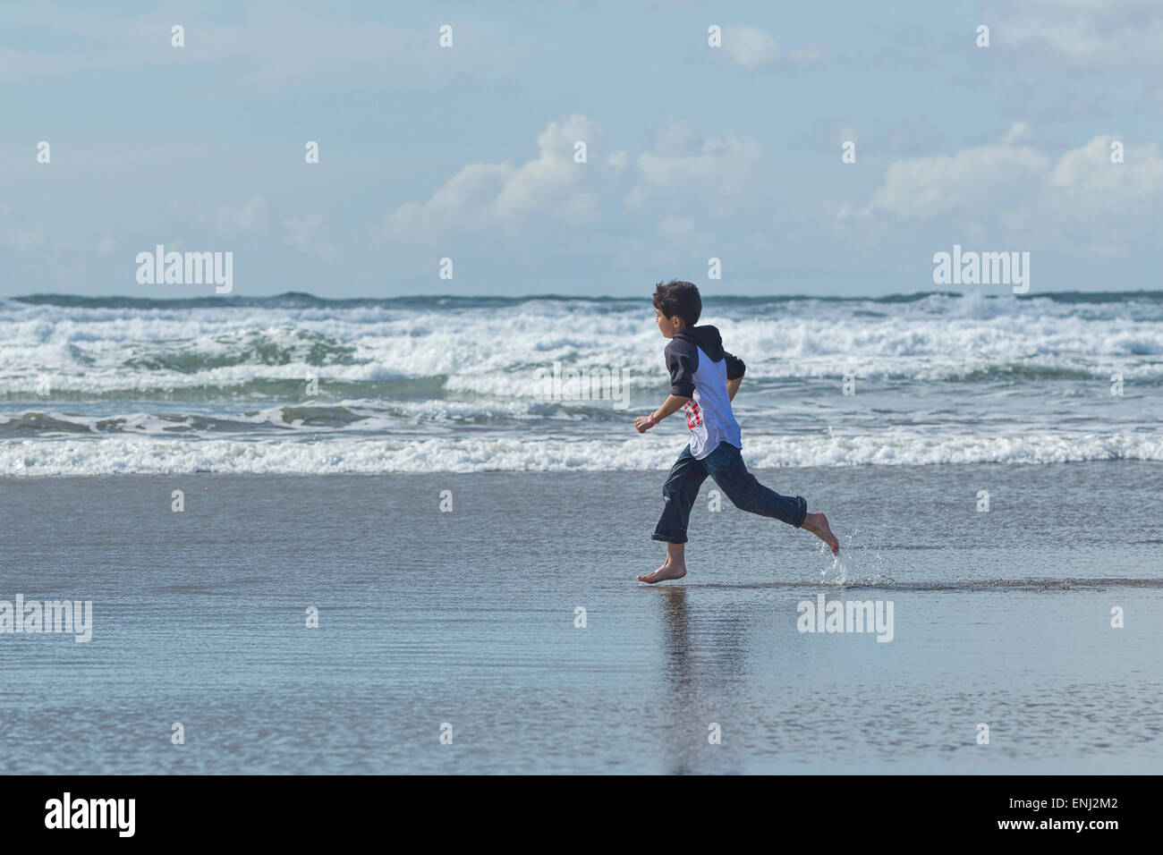 Boy runs in the sand Stock Photo - Alamy