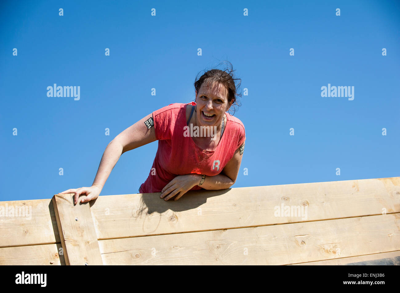 Women climbing the 10 foot wall and helping each other, Dirty Dozen ...