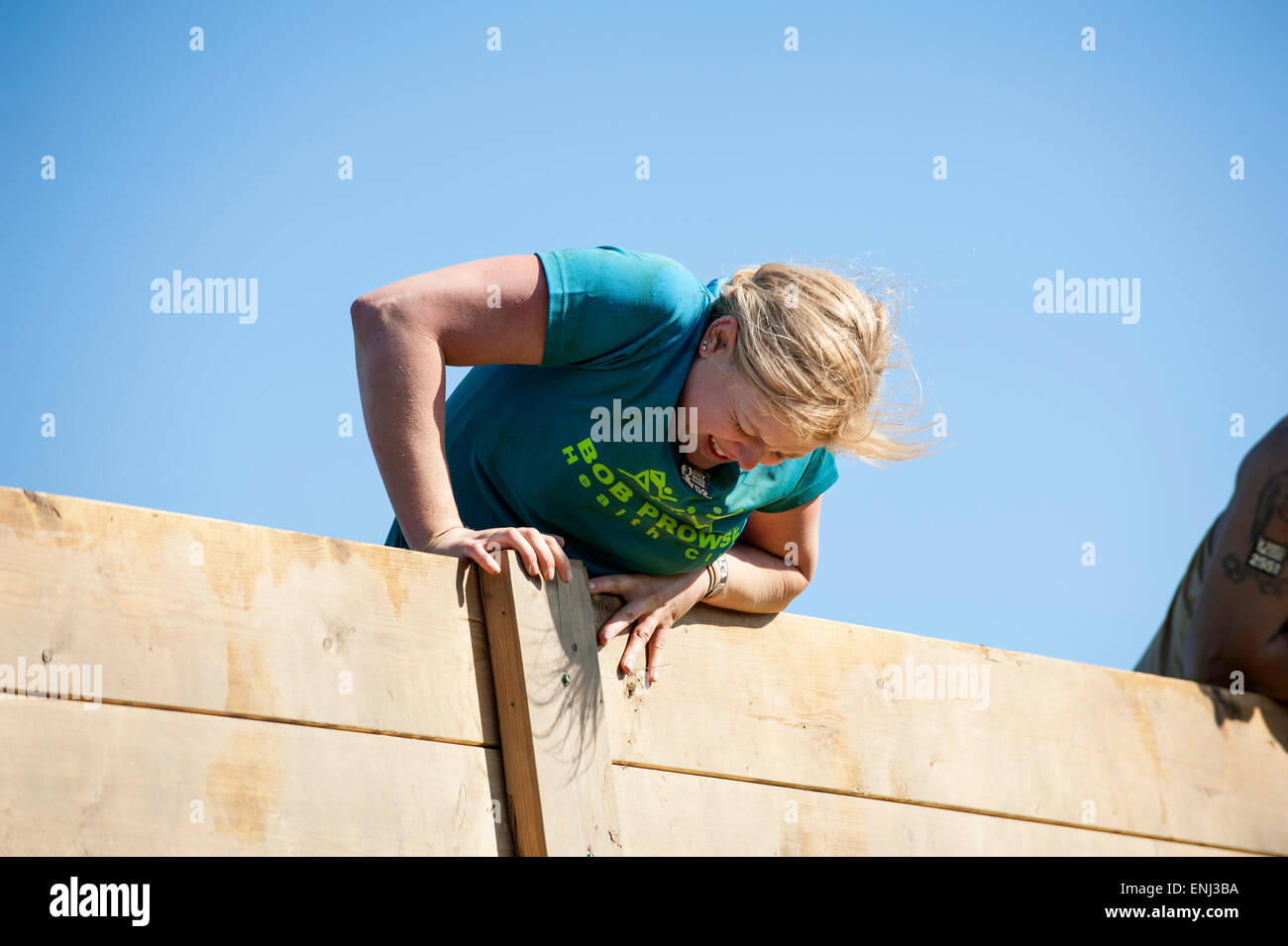 Women climbing the 10 foot wall and helping each other, Dirty Dozen ...