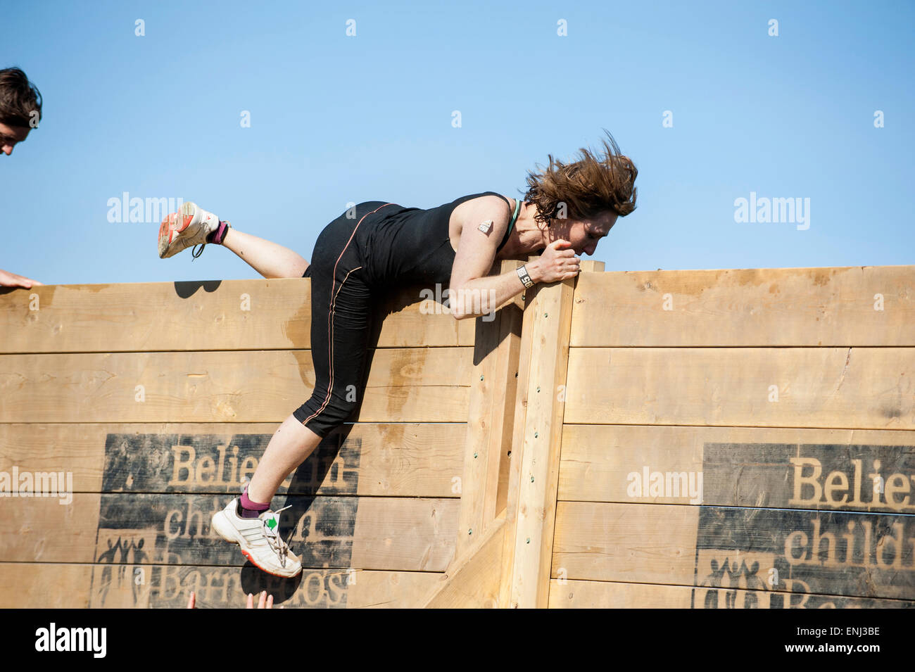 Women climbing the 10 foot wall and helping each other, Dirty Dozen ...