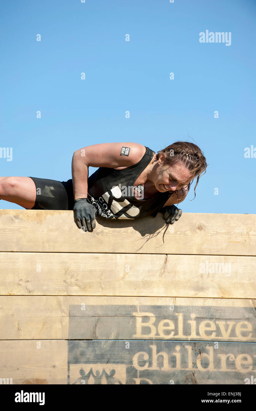 Women climbing the 10 foot wall and helping each other, Dirty Dozen ...