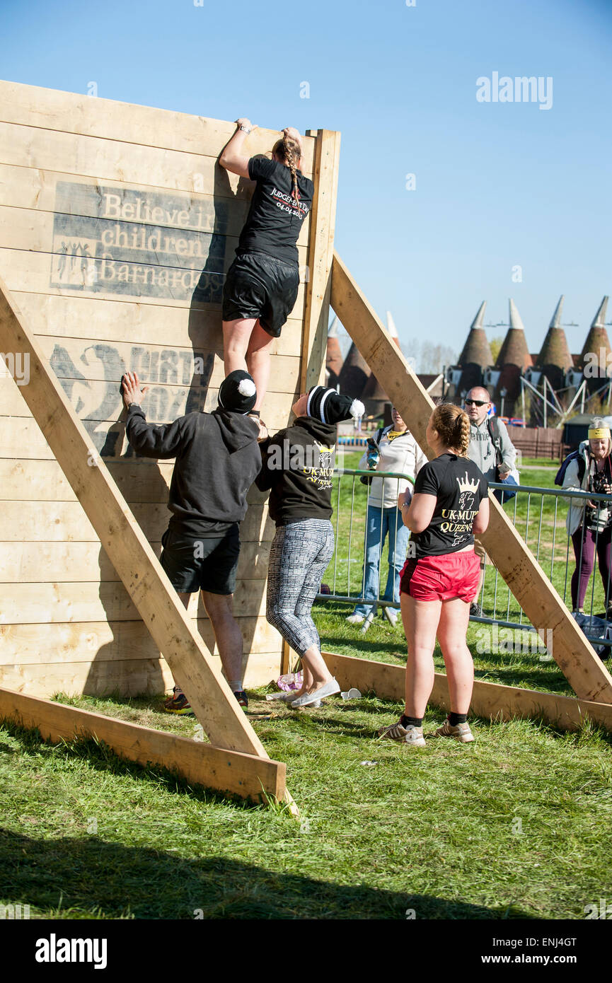 Women climbing the 10 foot wall and helping each other, Dirty Dozen ...