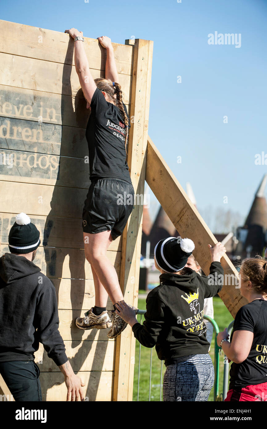 Women climbing the 10 foot wall and helping each other, Dirty Dozen ...