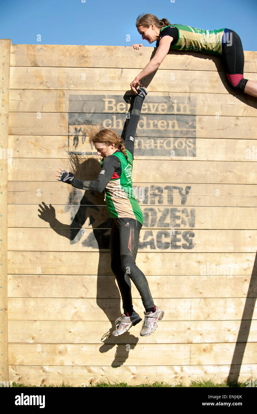 Women climbing the 10 foot wall and helping each other, Dirty Dozen ...