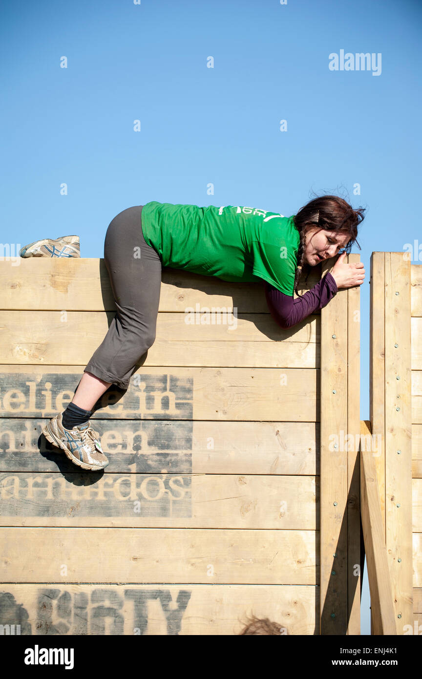 Women climbing the 10 foot wall and helping each other, Dirty Dozen ...