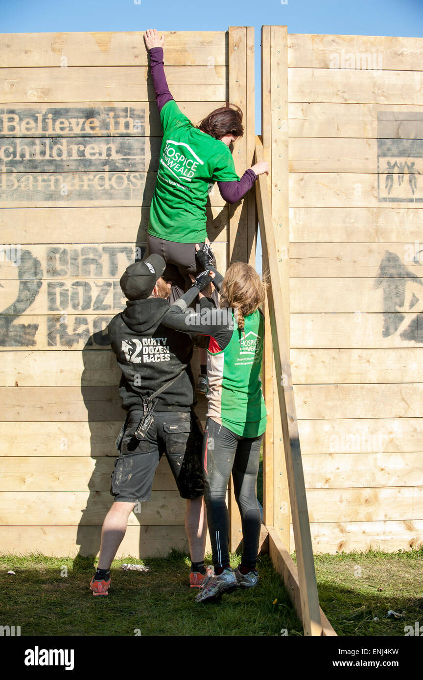 Women climbing the 10 foot wall and helping each other, Dirty Dozen ...