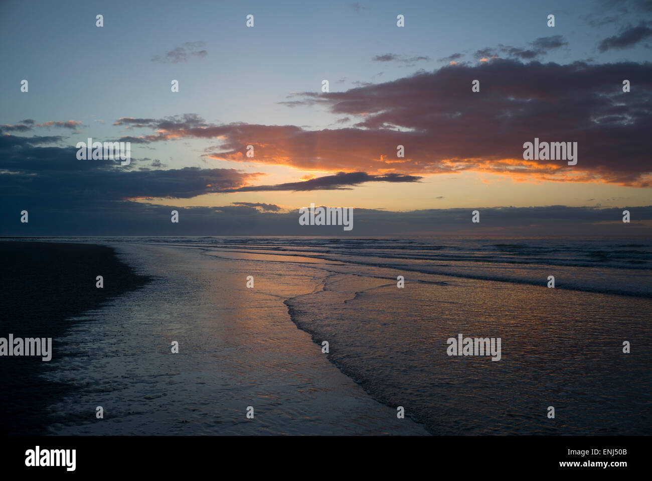 Sunset through clouds over calm sea, Normandy, France Stock Photo - Alamy