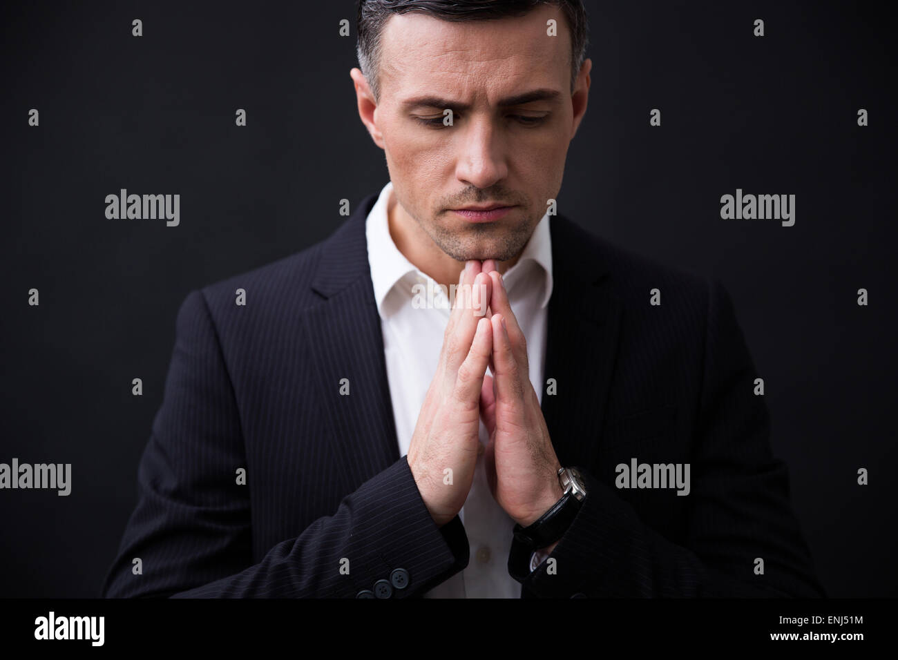 Praying man suit hi-res stock photography and images - Alamy