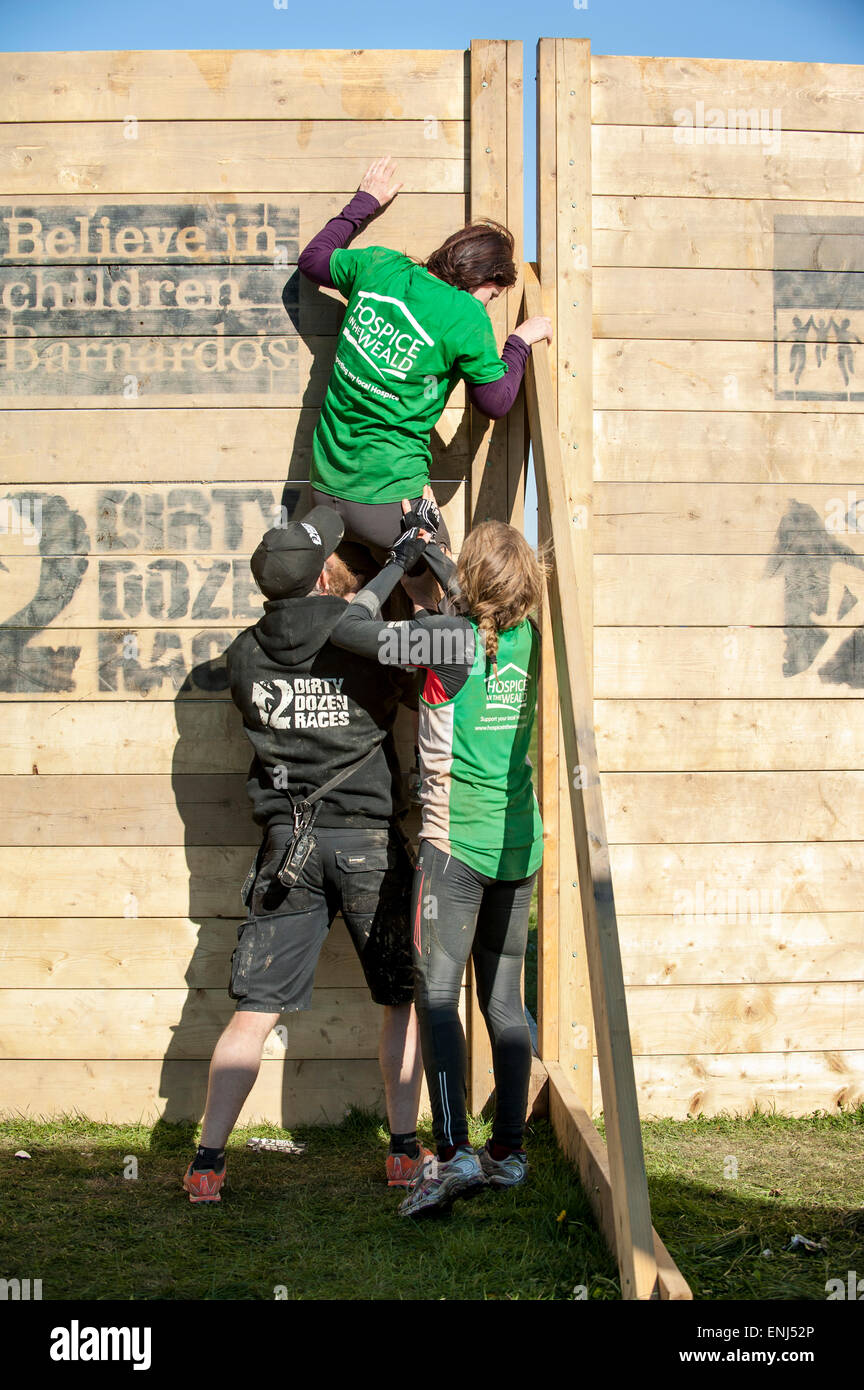 Women climbing the 10 foot wall and helping each other, Dirty Dozen ...
