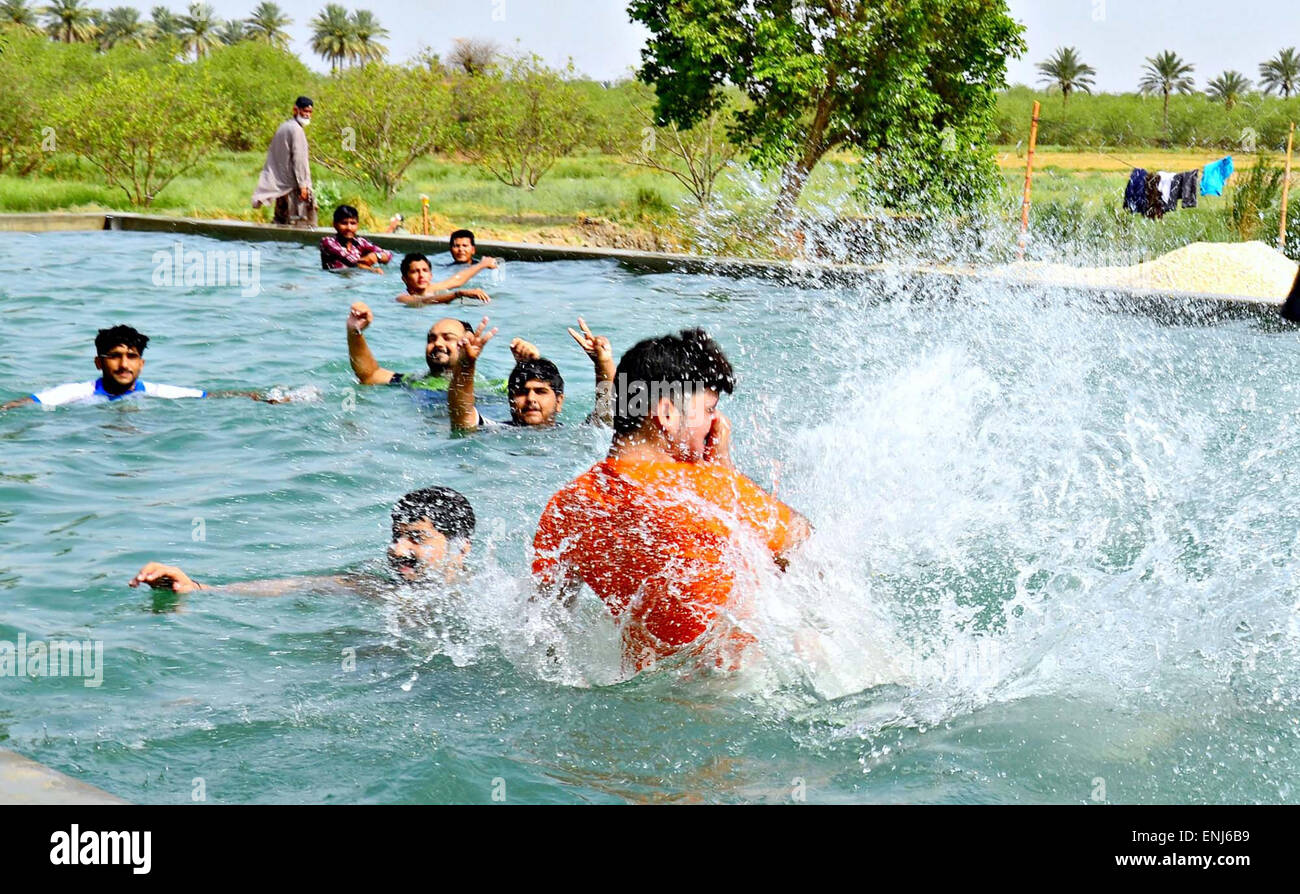 People enjoy bath at a swimming pool during hot day of summer season at ...