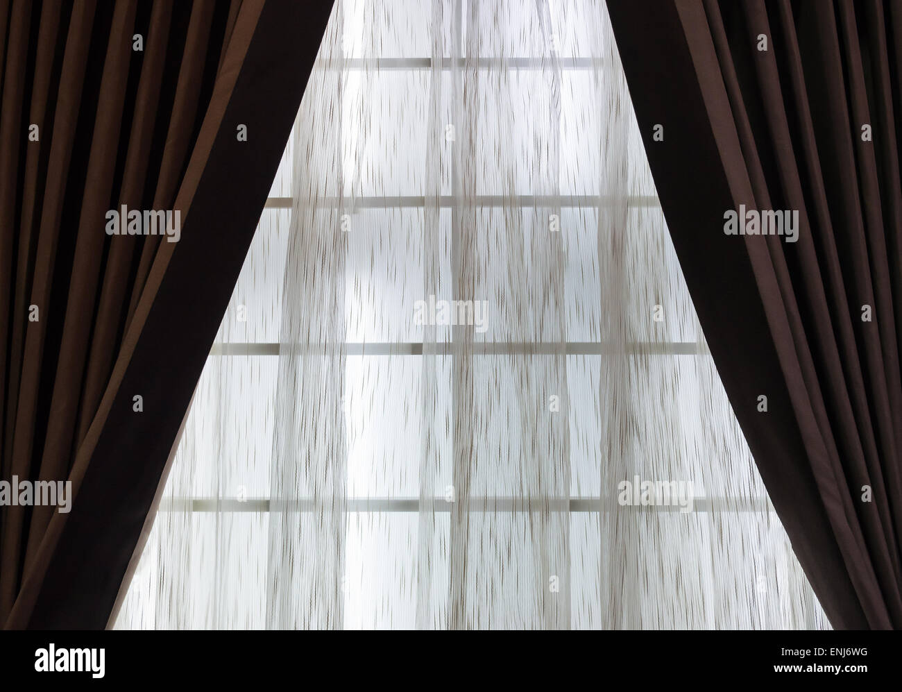 Brown curtain with translucent fabric on the window of living room ...