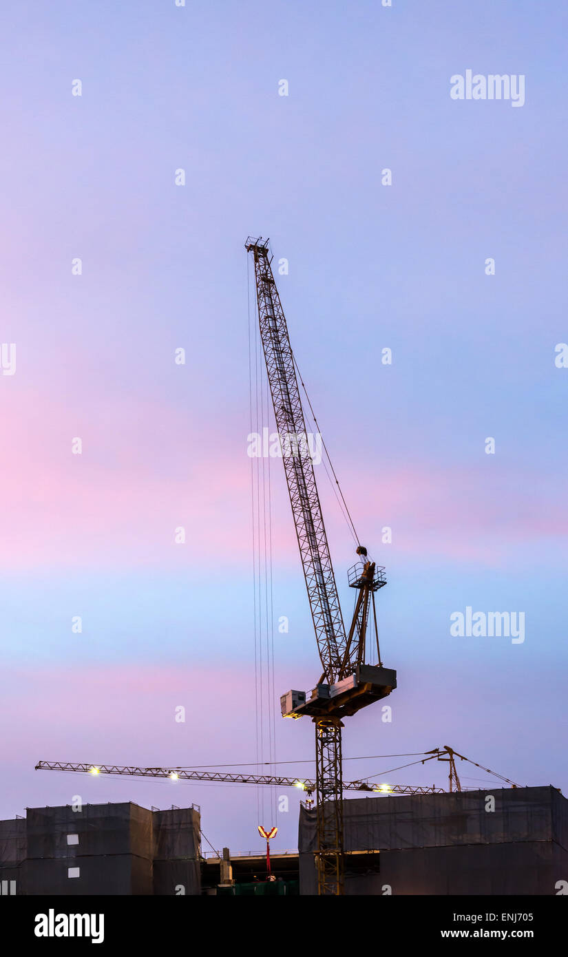 Modern crane on the construction building in twilight time Stock Photo ...
