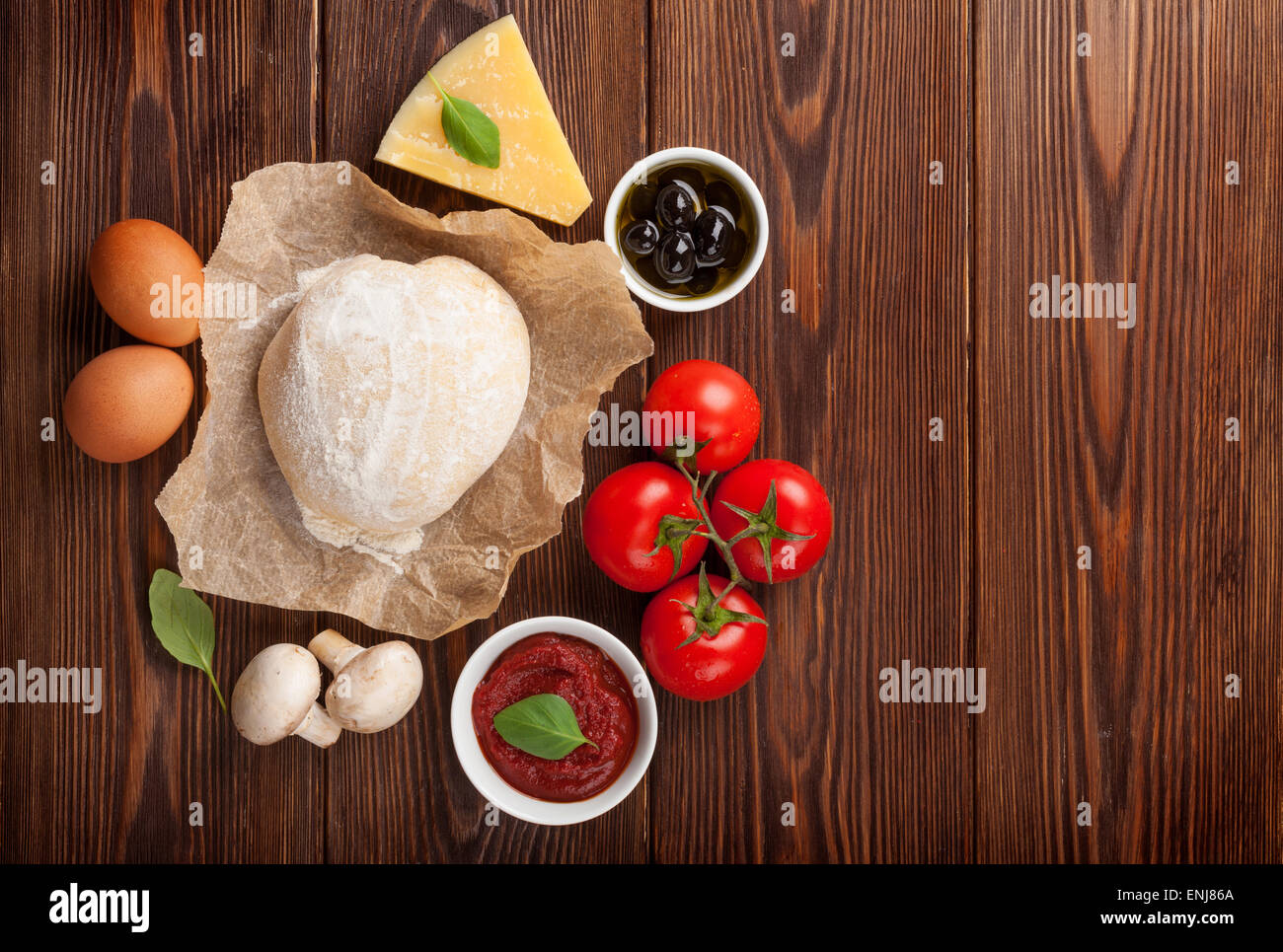 Pizza cooking ingredients. Dough, vegetables and spices. Top view with ...