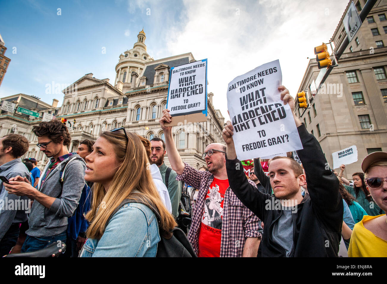 Protesters with signs marching by congregating by City Hall in downtown ...