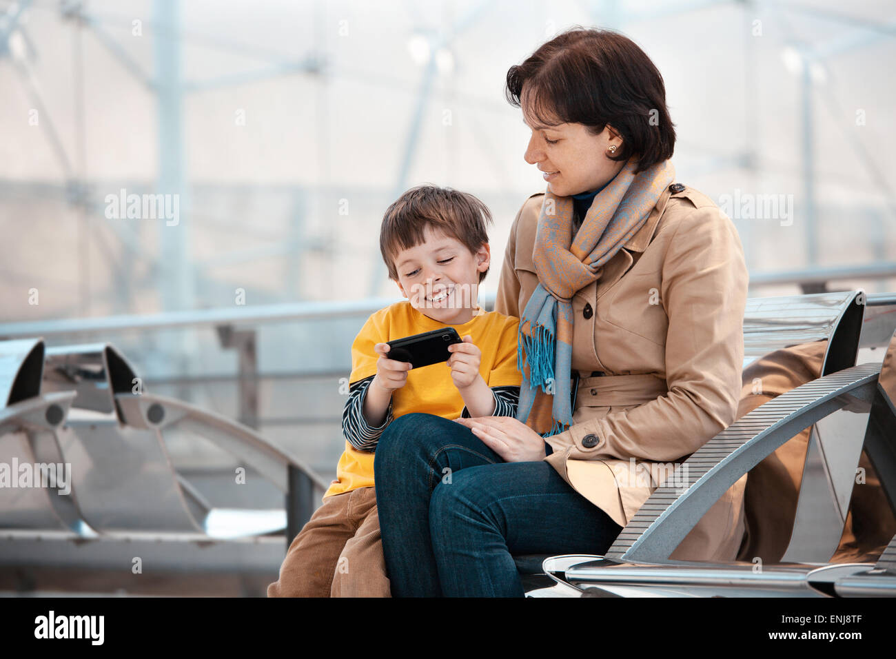 Loving mother and son using smartphone Stock Photo - Alamy