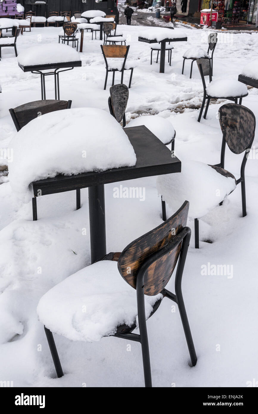Snow and ice covering cafe chairs and tables at Karakoy, Istanbul ...