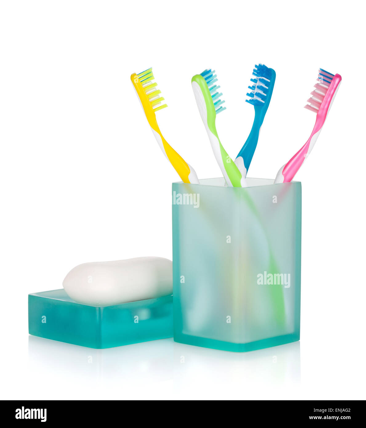 Four multicolored toothbrushes and soap. Isolated on white background ...