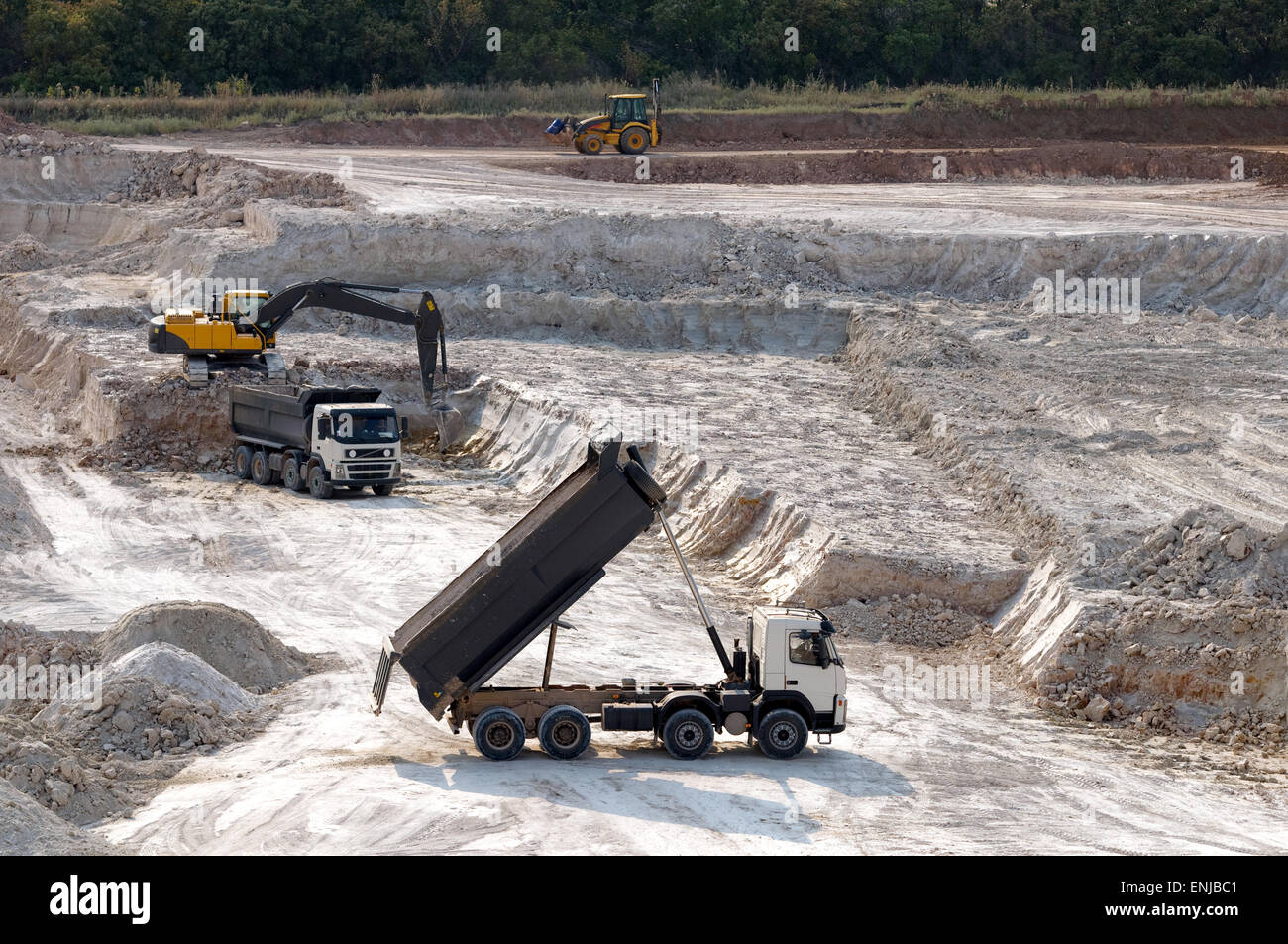 loading machine produces crushed stone for a career Stock Photo - Alamy