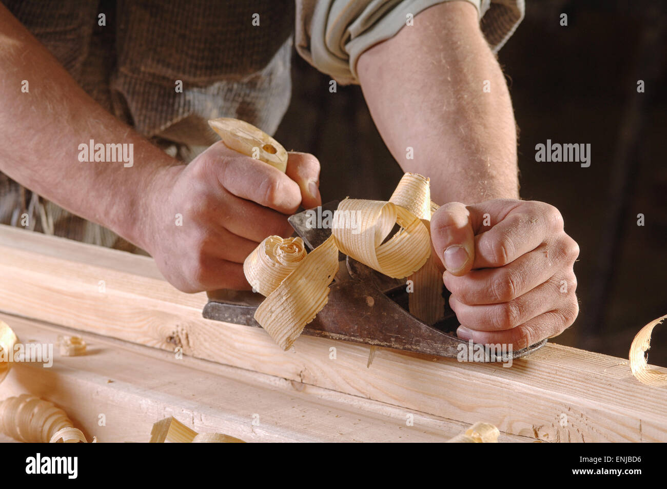 Man hands with carpenters plane on wooden background Stock Photo - Alamy