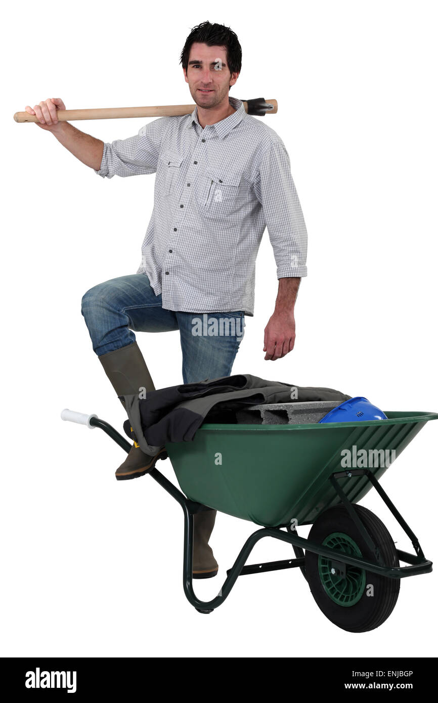 Person pushing red wheelbarrow Cut Out Stock Images & Pictures - Alamy
