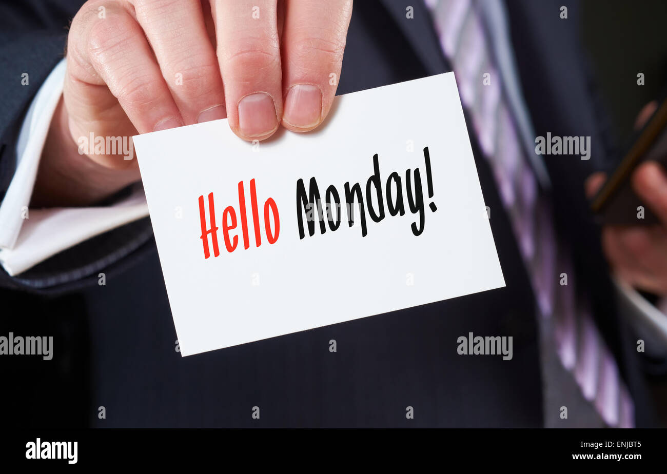 A businessman holding a business card with the words, Hello Monday ...