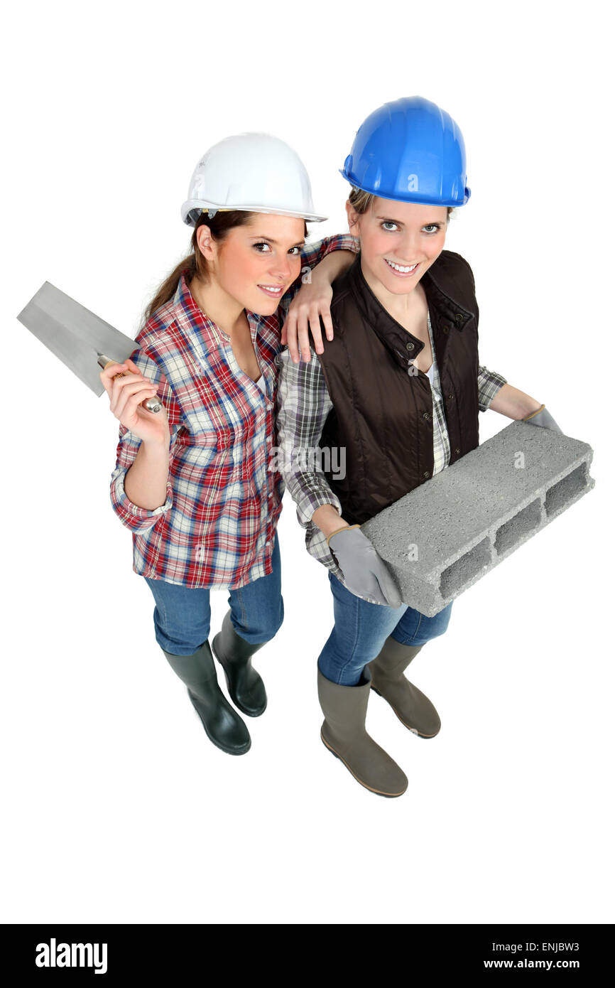 two female builders posing Stock Photo - Alamy