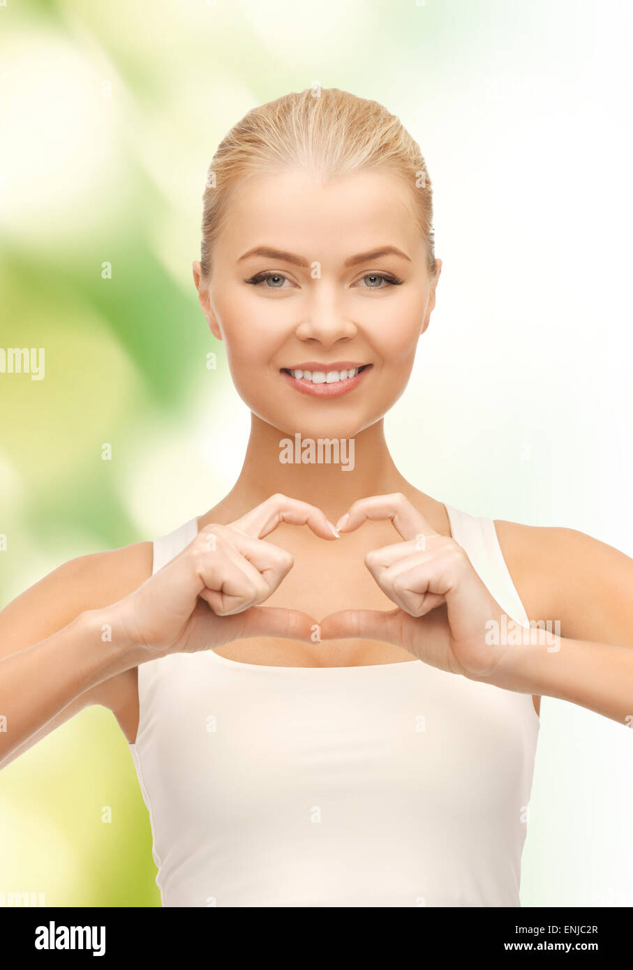 smiling woman showing heart shape gesture Stock Photo - Alamy