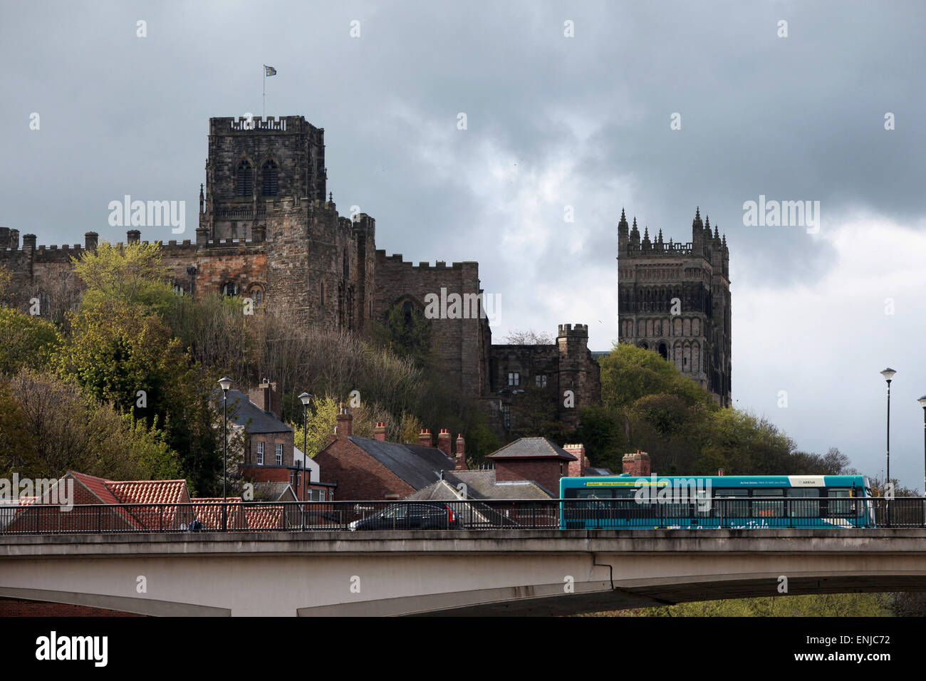 A bus driving though Durham with Durham Cathedral and Durham Castle in ...