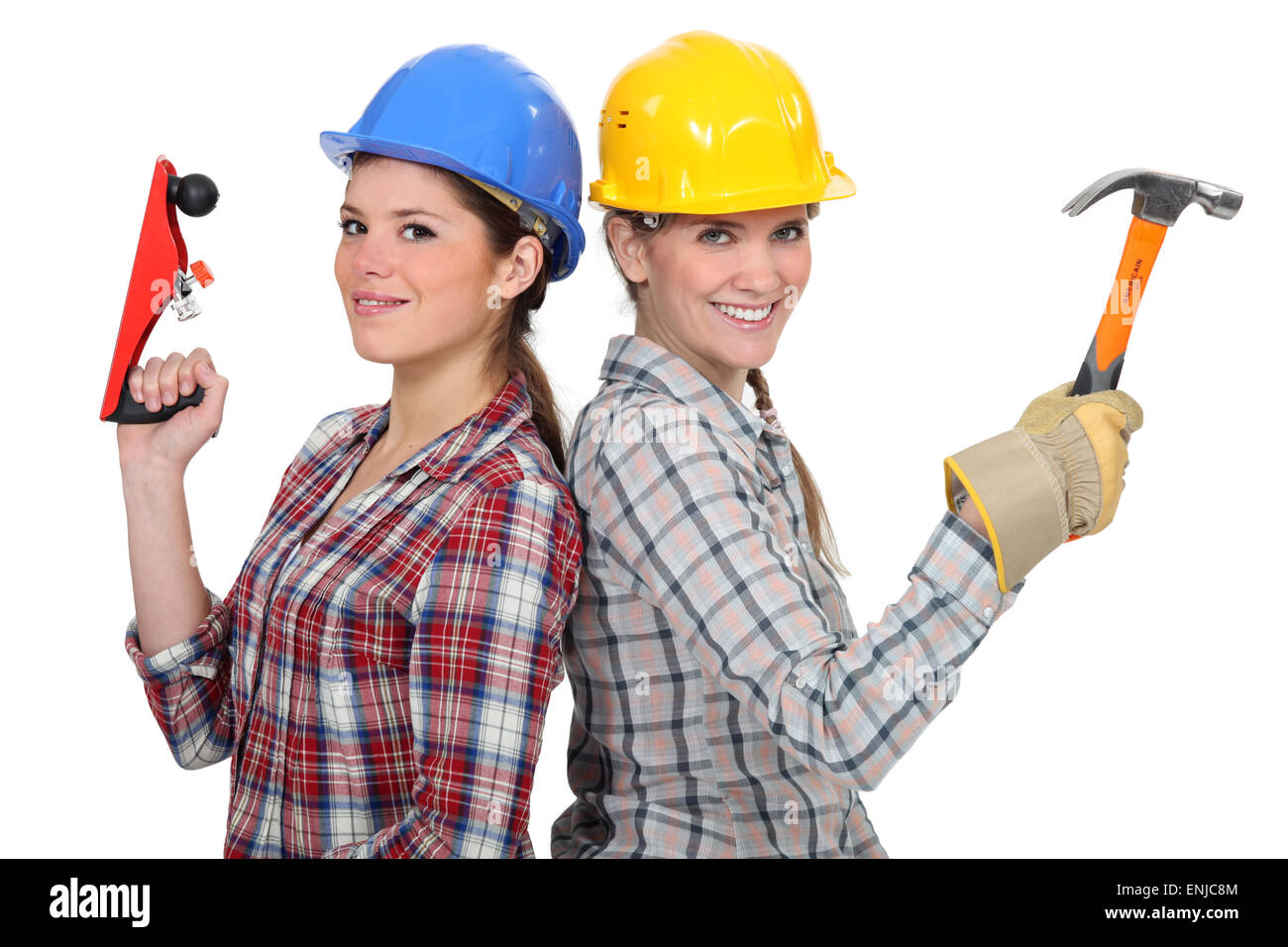 Tradeswomen holding tools Stock Photo - Alamy