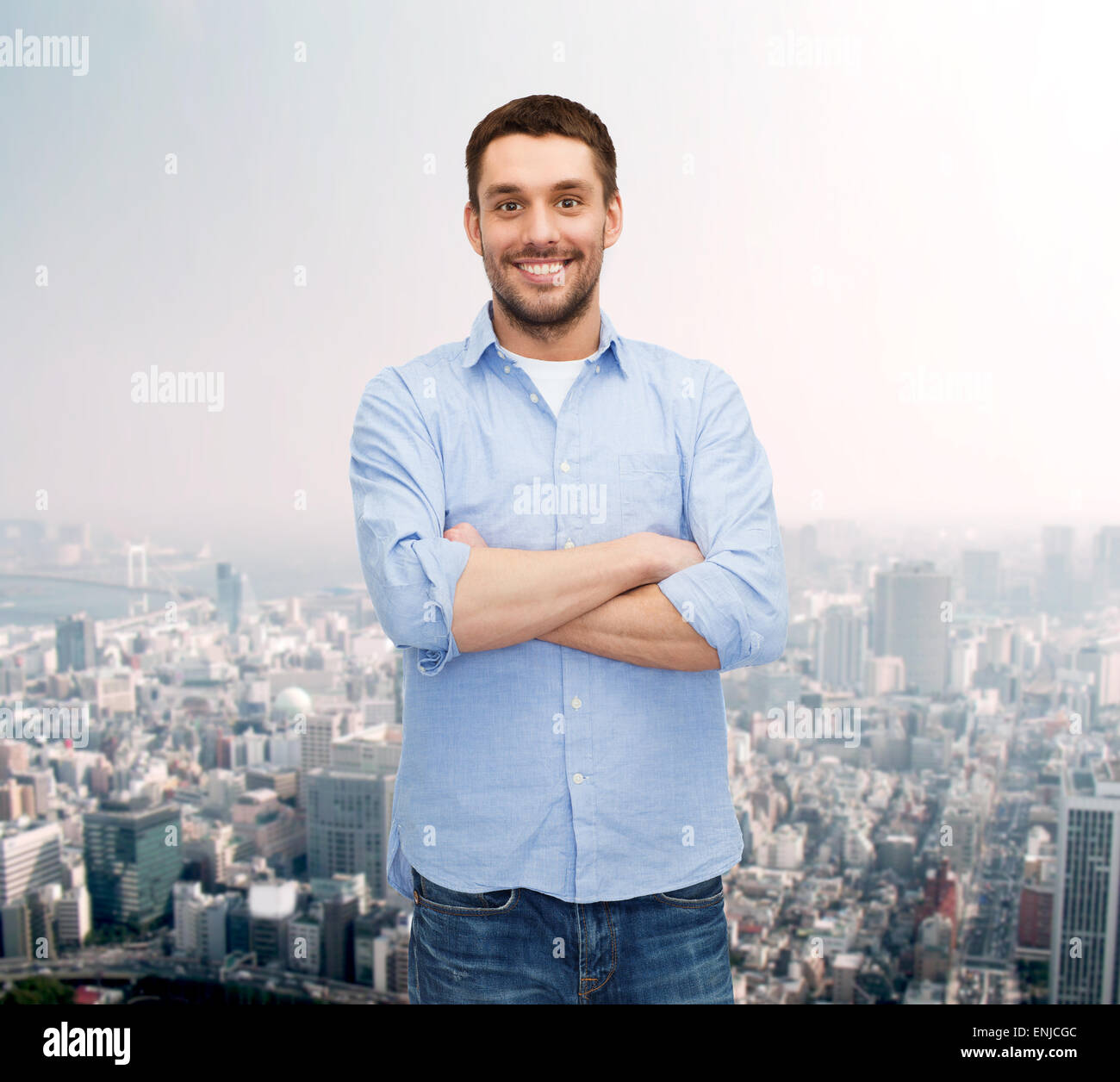 smiling man with crossed arms Stock Photo - Alamy
