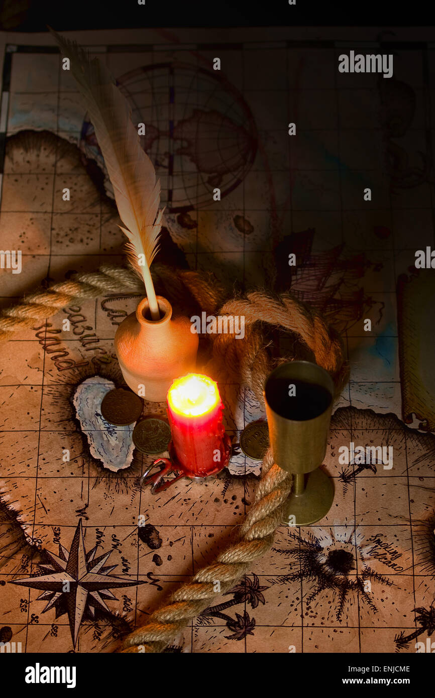 Dark image Old map, a candle and the rope inkwell and quill Stock Photo ...