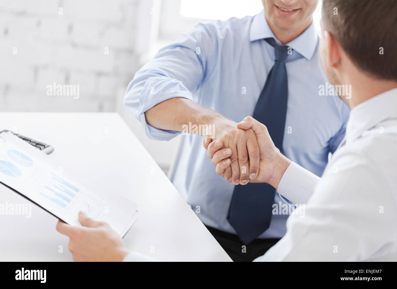 businessmen shaking hands in office Stock Photo - Alamy