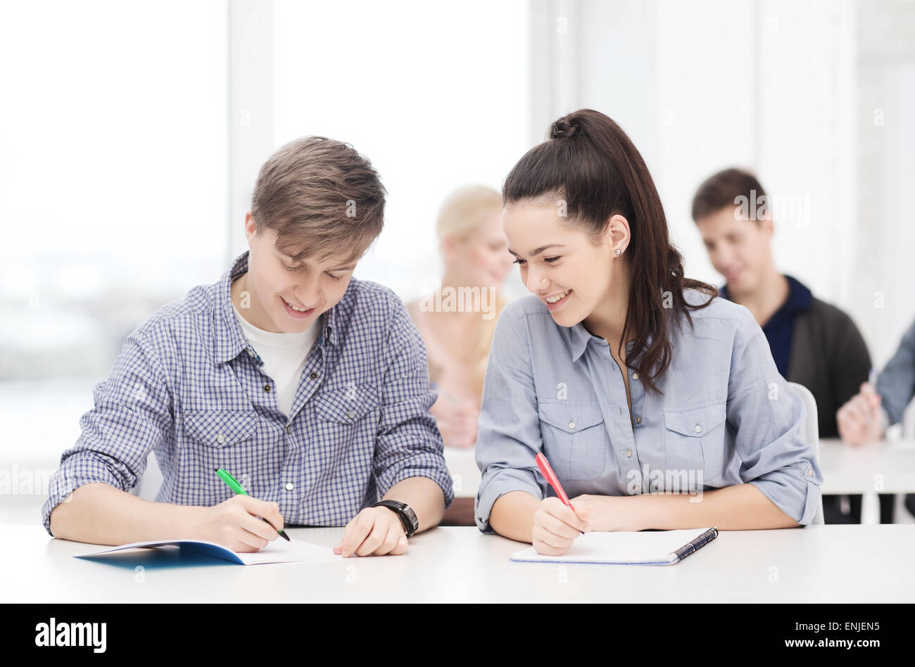 two teenagers with notebooks at school Stock Photo - Alamy