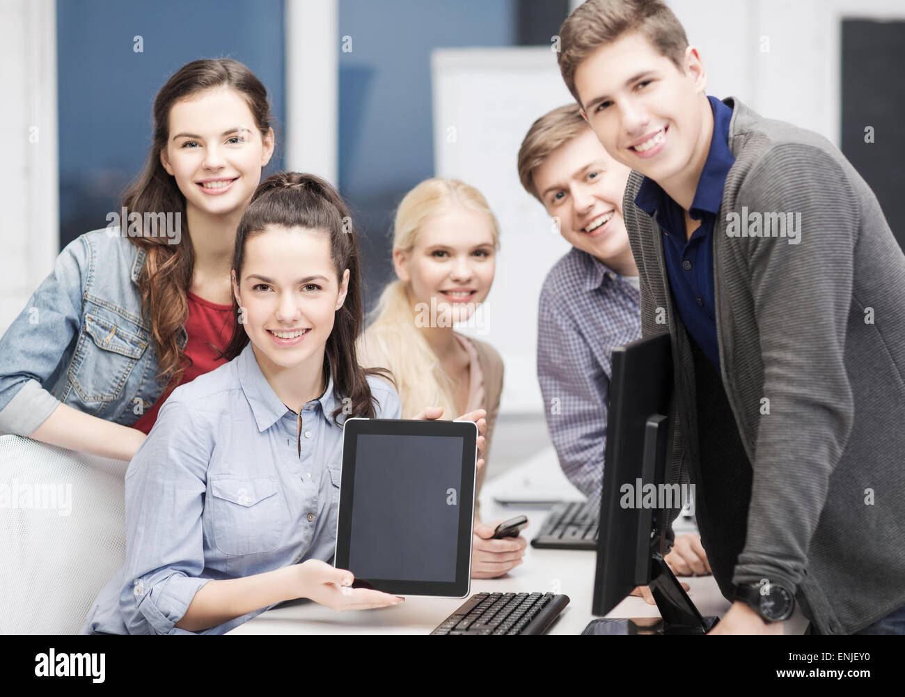 students with monitor and blank tablet pc screen Stock Photo - Alamy