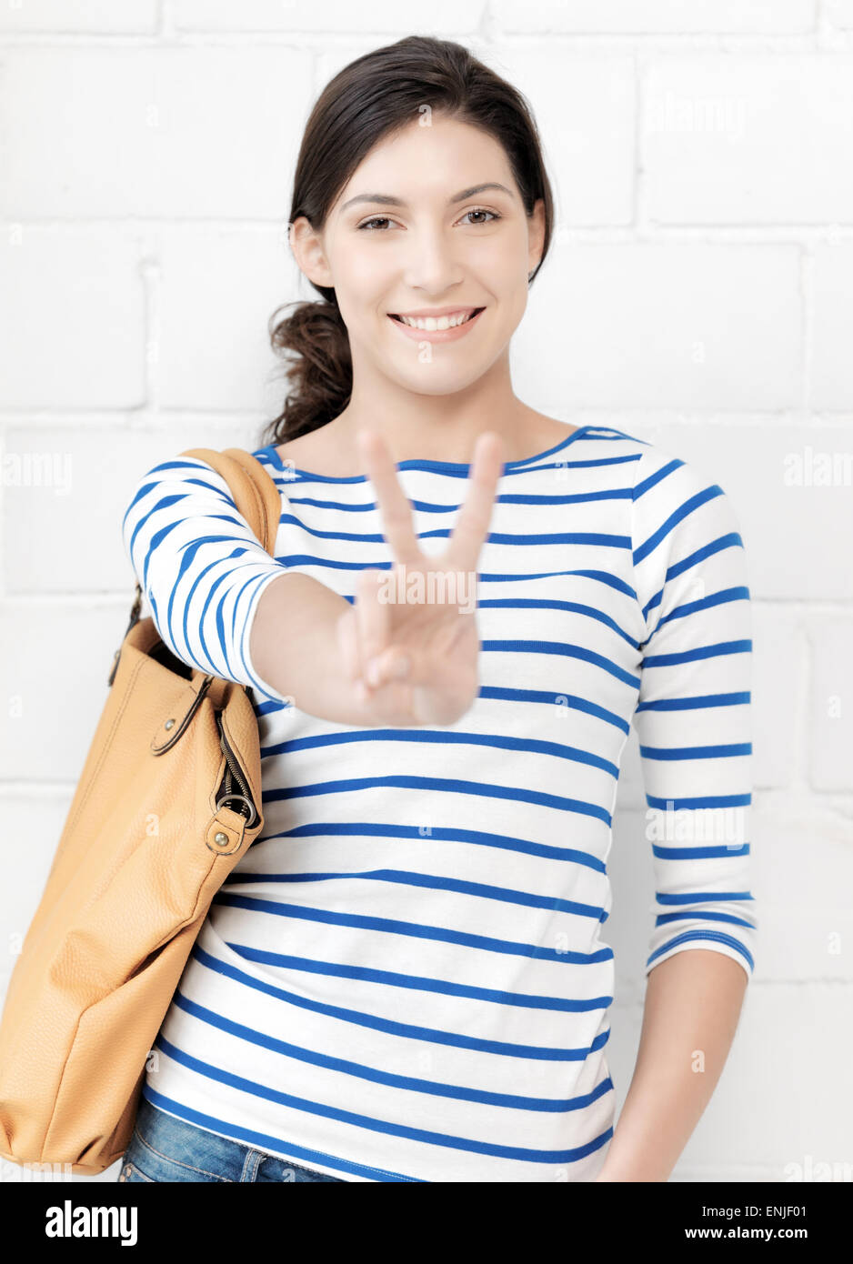lovely teenage girl showing v-sign Stock Photo - Alamy