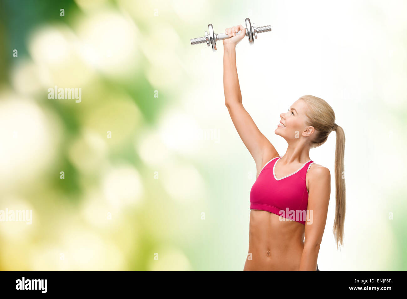 smiling woman with heavy steel dumbbell Stock Photo - Alamy