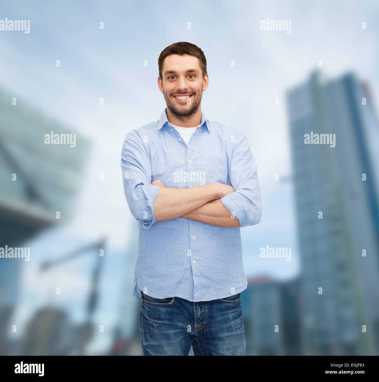 smiling man with crossed arms Stock Photo - Alamy