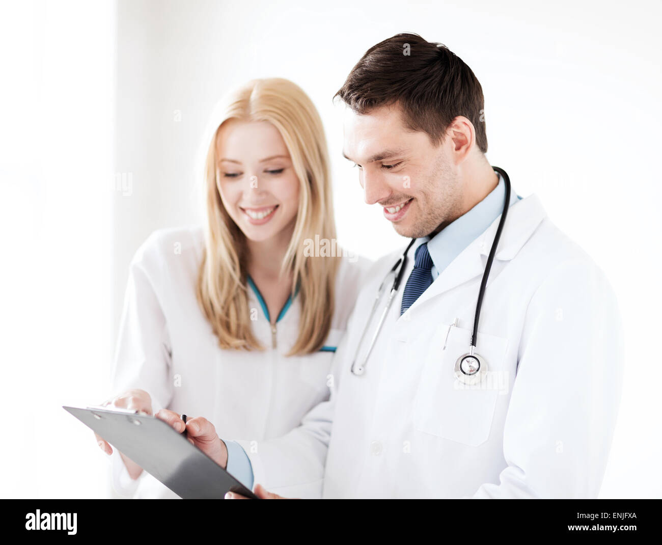two doctors writing prescription Stock Photo - Alamy