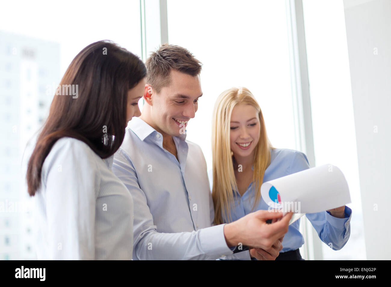 business team looking at clipboard Stock Photo - Alamy