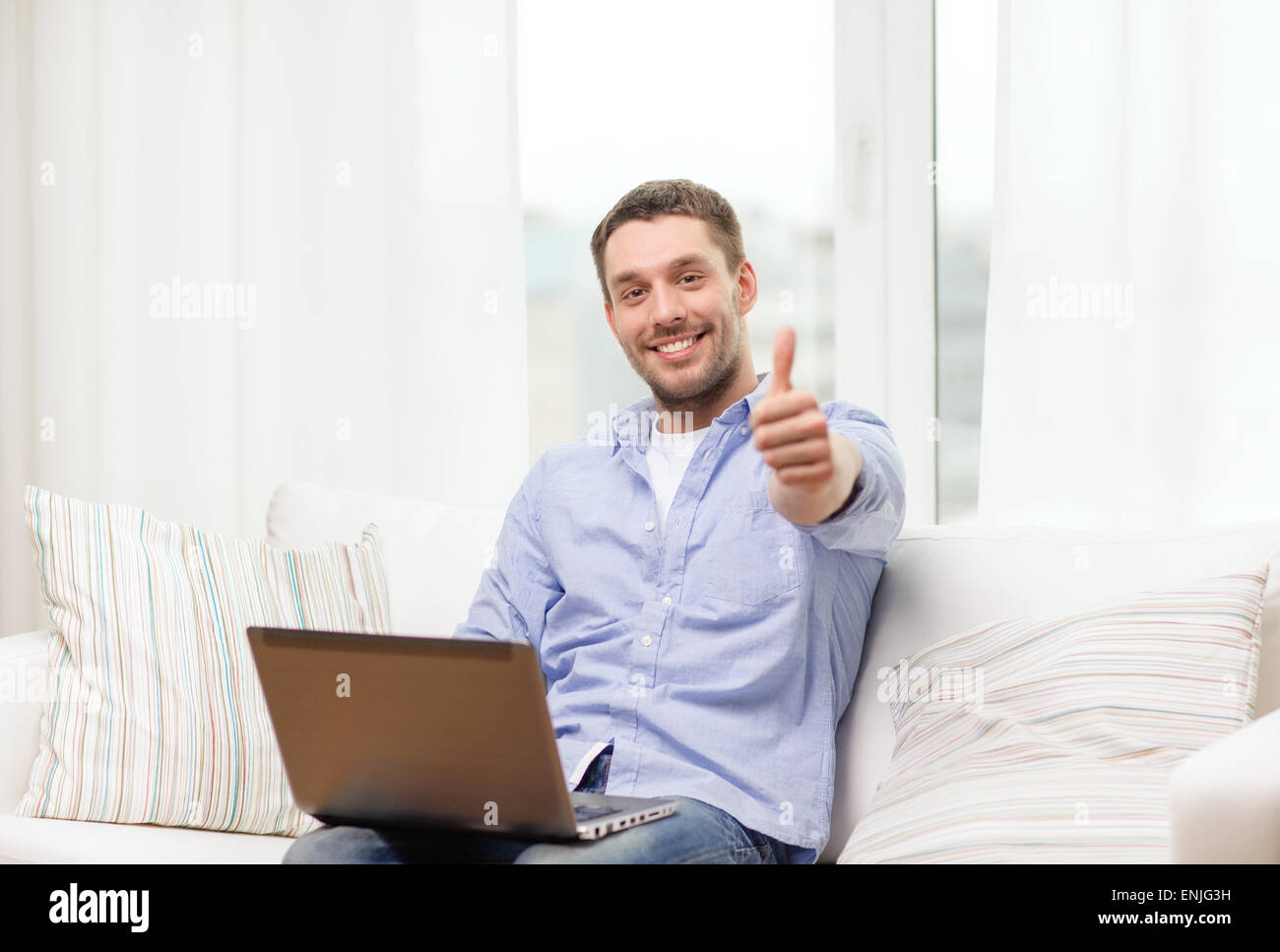 smiling man working with laptop at home Stock Photo - Alamy