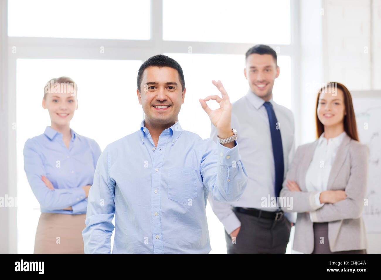 smiling businessman showing ok-sign in office Stock Photo - Alamy