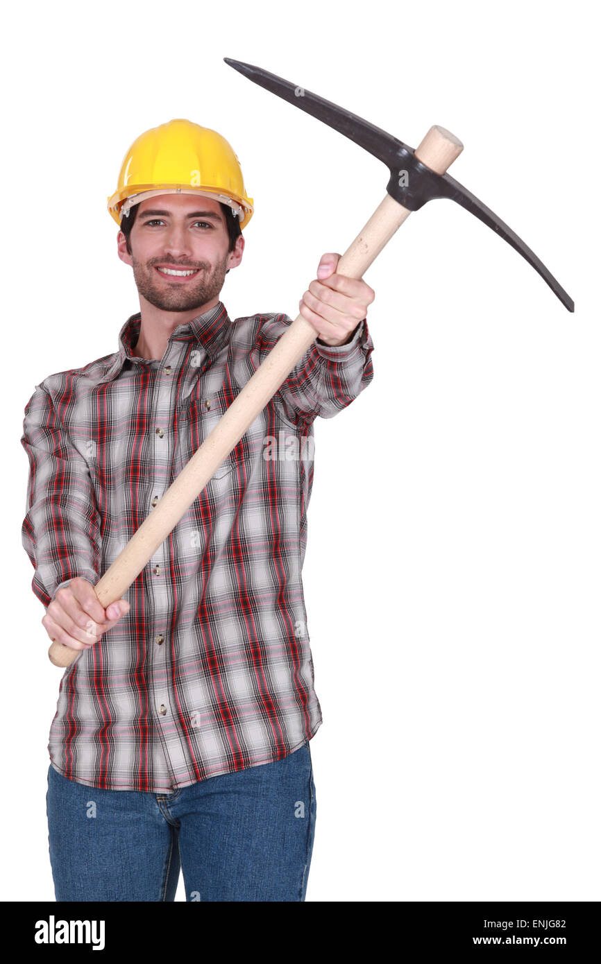 Tradesman holding up a pickaxe Stock Photo - Alamy