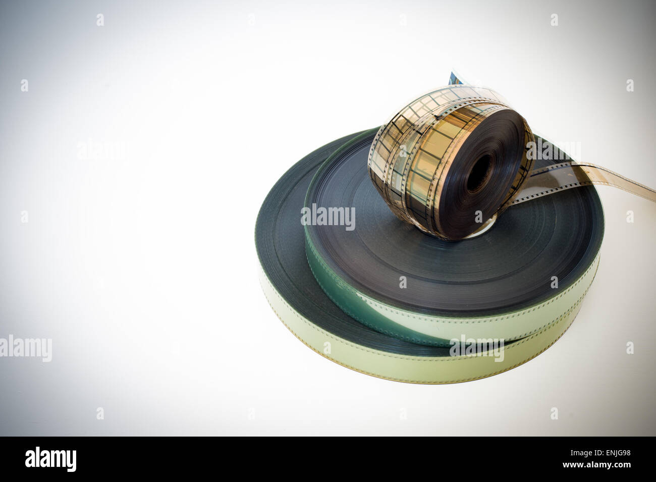 Three 35mm movie rolls on neutral background in vintage color effect ...