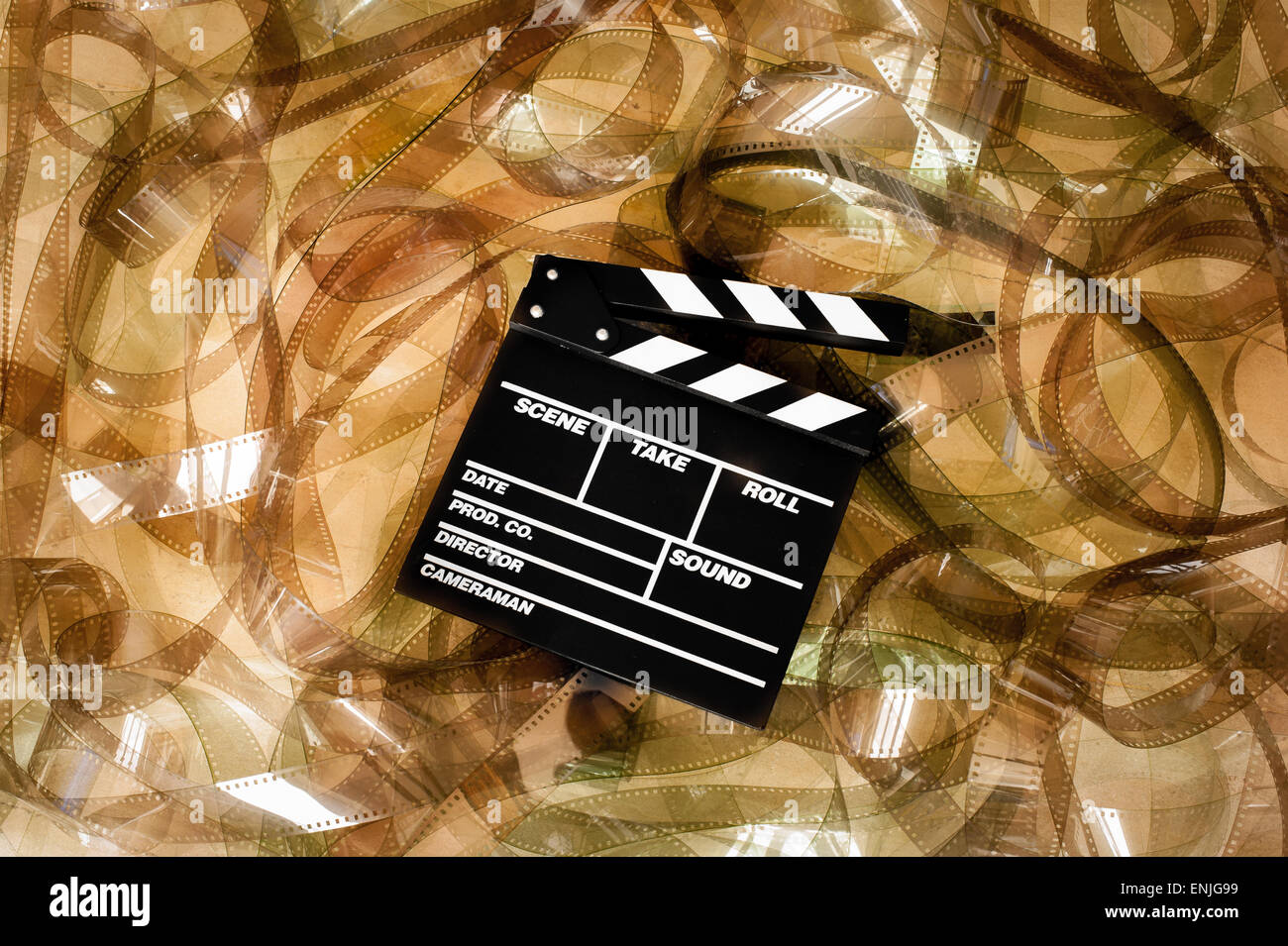 Clapper board on 35mm unrolled movie filmstrip blank frames carpet ...