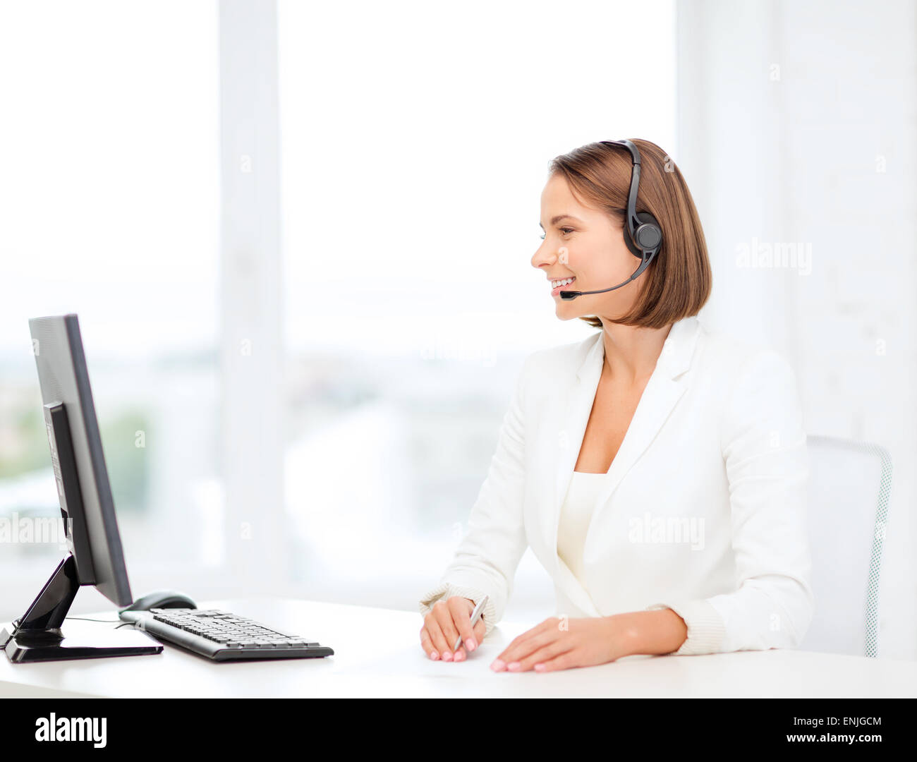 friendly female helpline operator with computer Stock Photo - Alamy