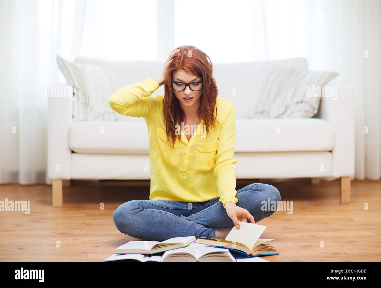 stressed student girl reading books at home Stock Photo - Alamy